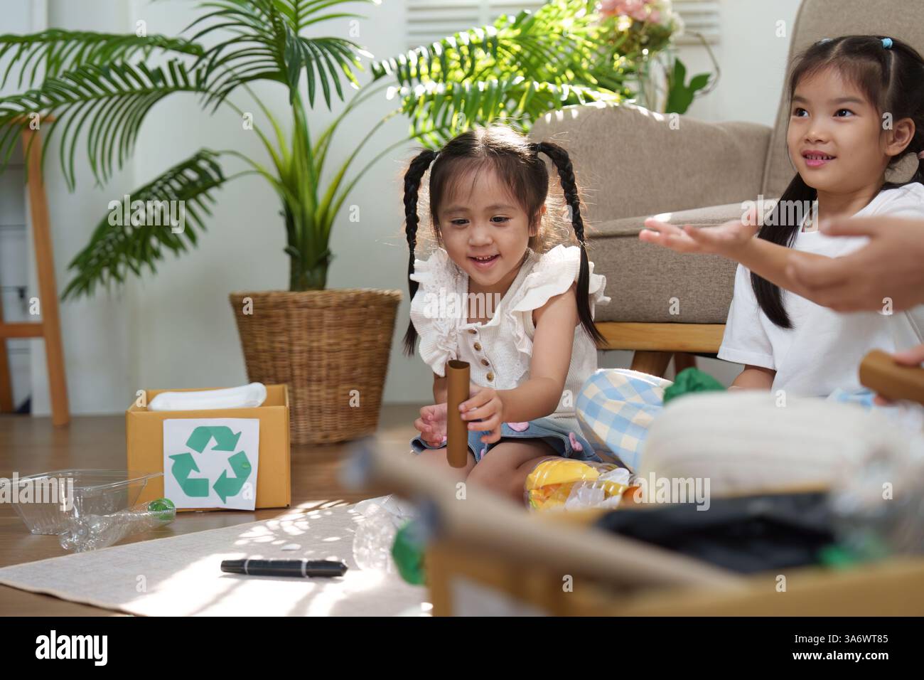 Learning and Imagination. Children creating art with recycled items at home, promoting eco ...