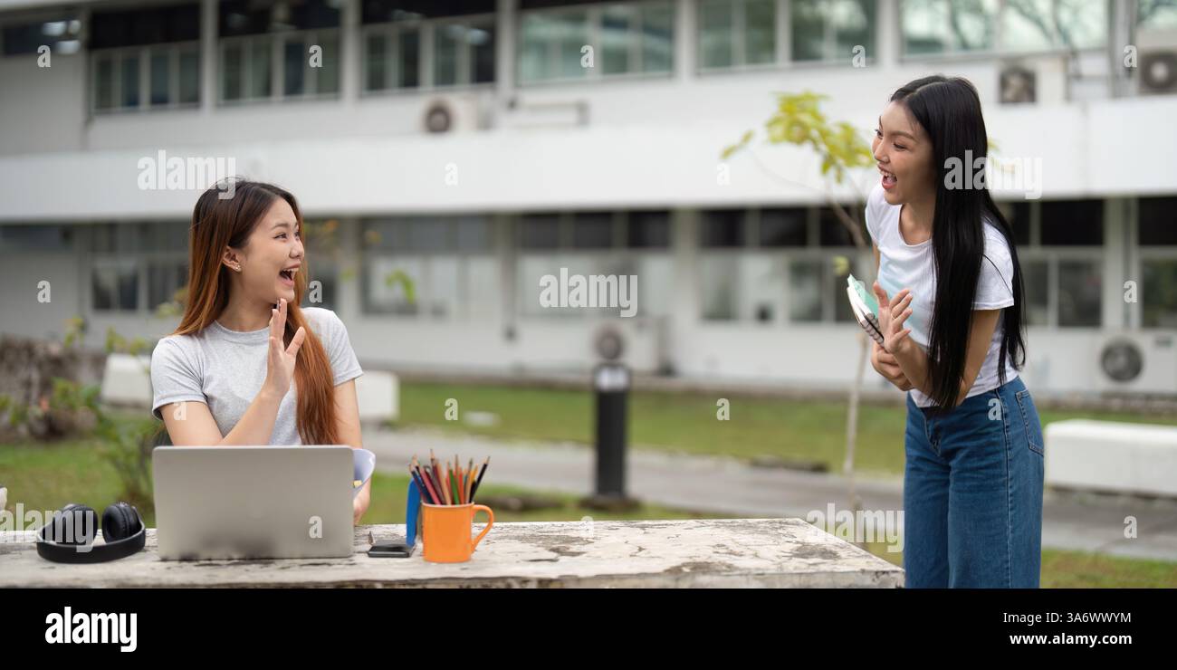 Friendship and Studying. Two students joyfully engaging in a lively ...