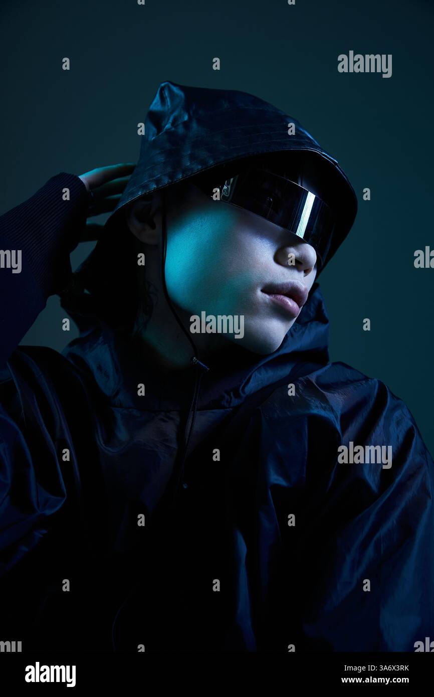 A stylish young Asian man poses confidently in a modern, cool ...