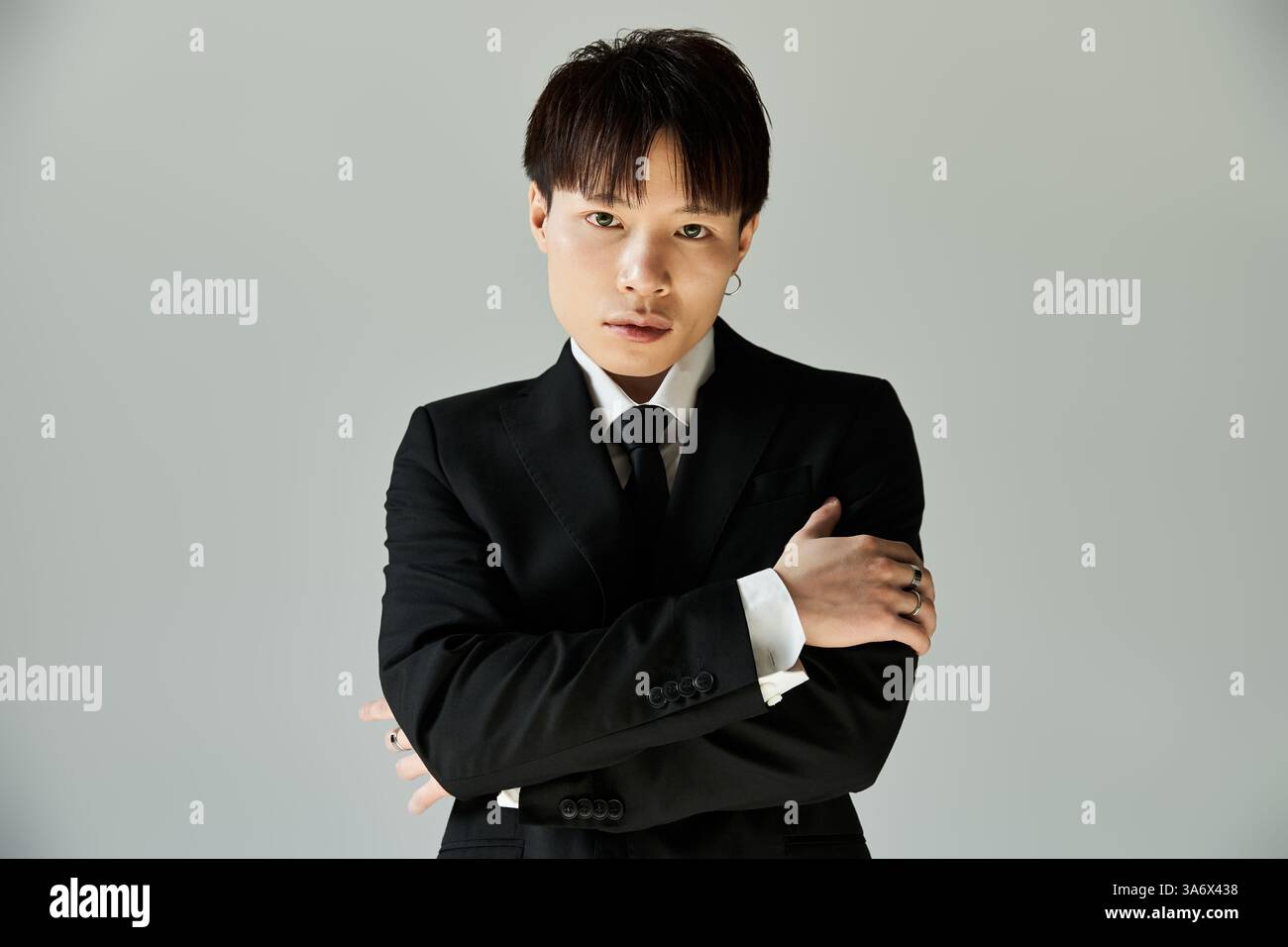 A handsome young man exudes charm and confidence while posing in a ...