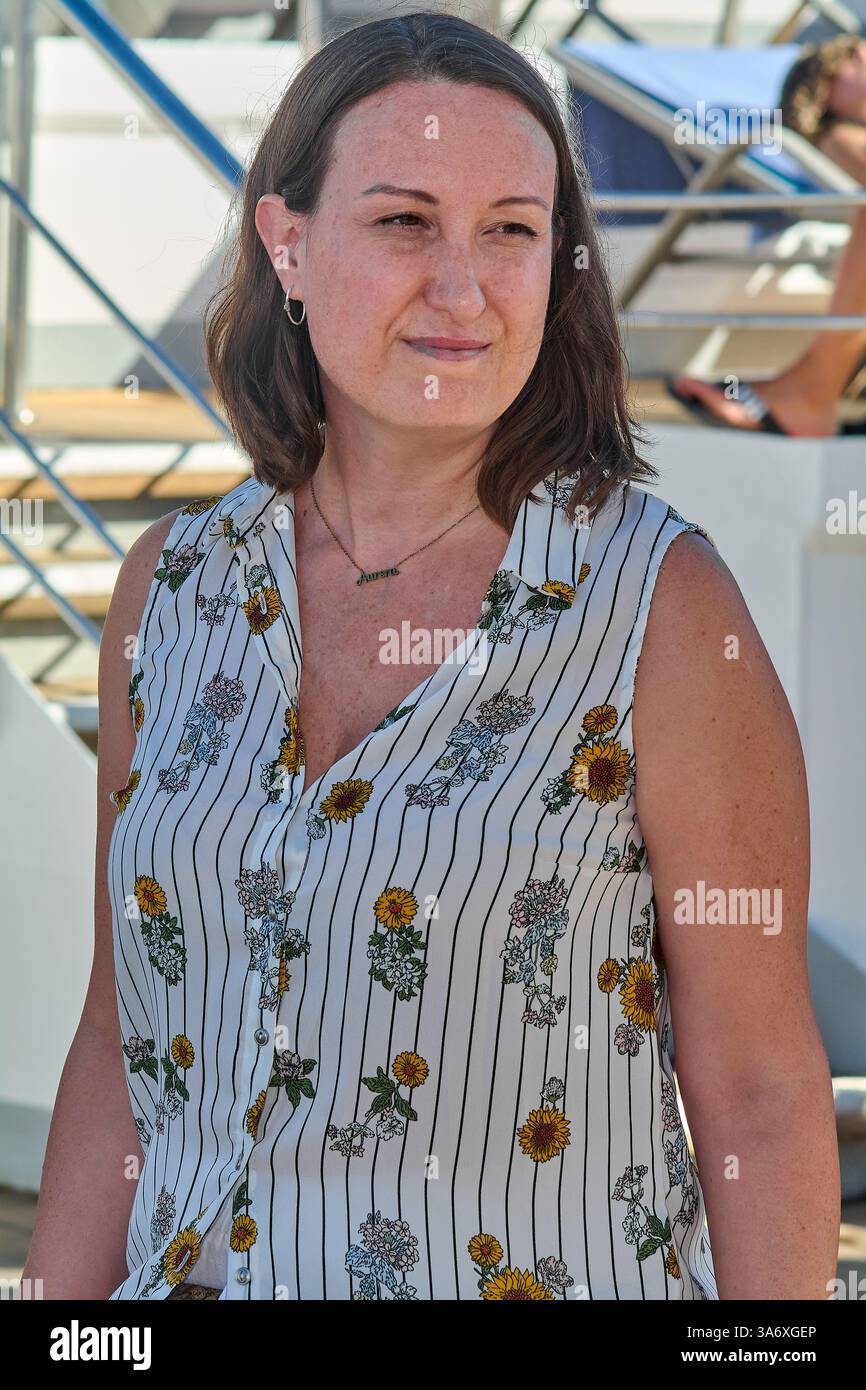 Elegant woman in colorful outfit wearing unique accessories. Image ...