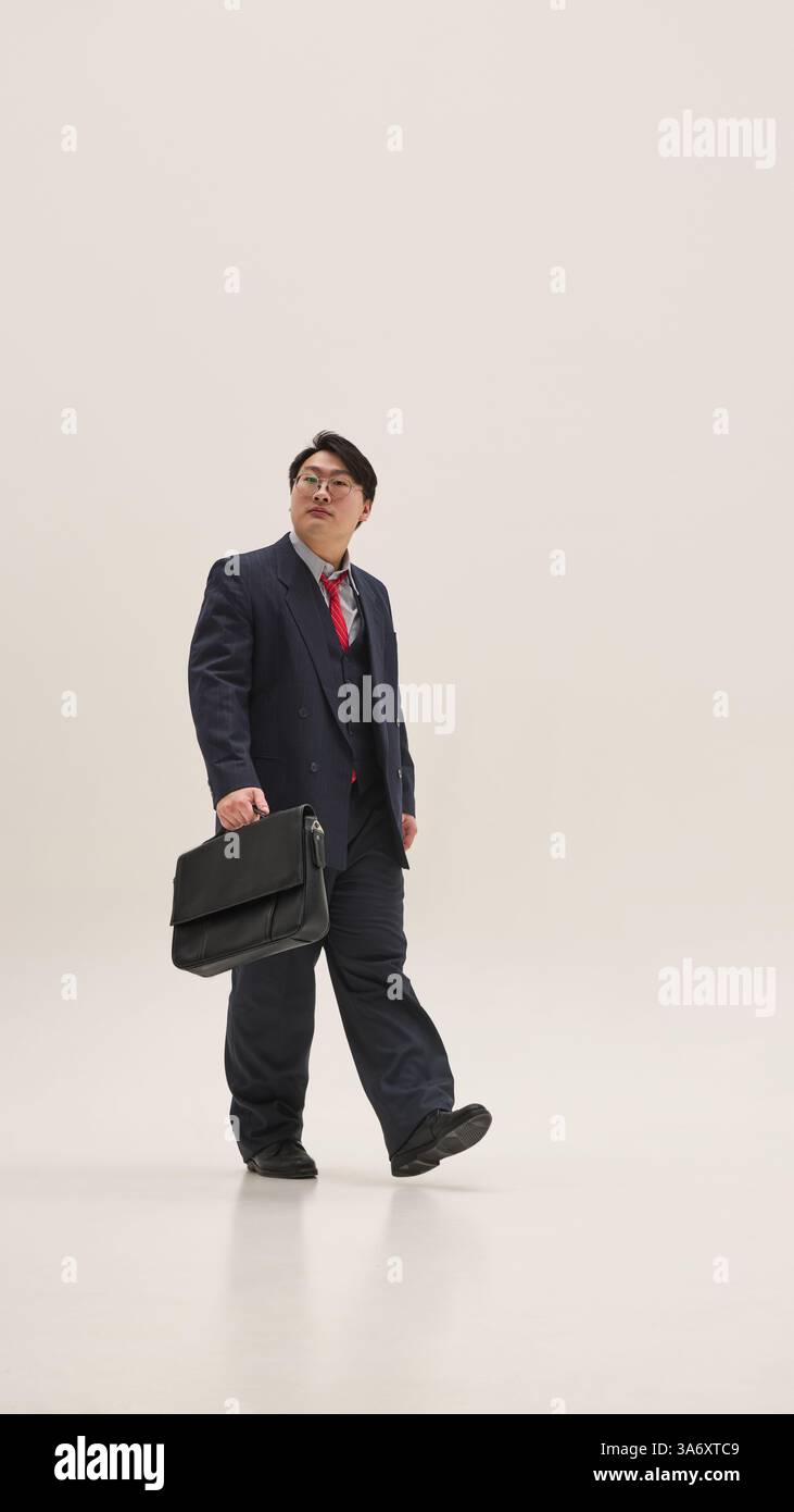 Dynamic photo of young attractive Asian man dressed formal attire ...