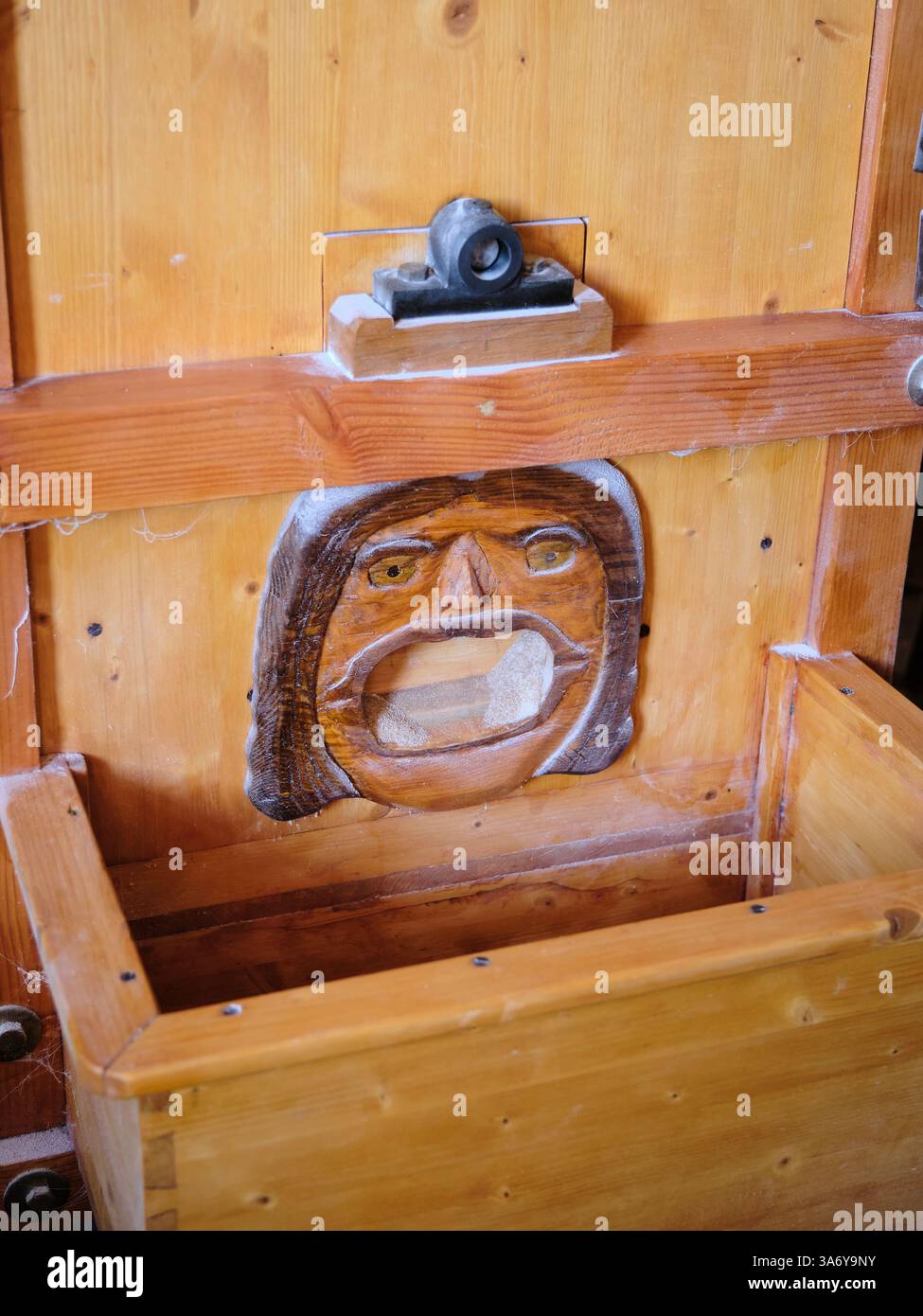 lose-up of the flour sieve outlet in a traditional watermill interior ...