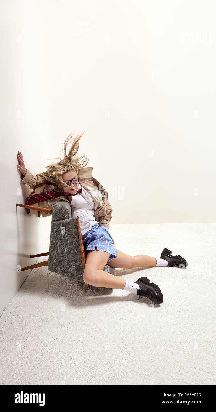 Modern employee juggling work and exhaustion, collapsed over chair ...