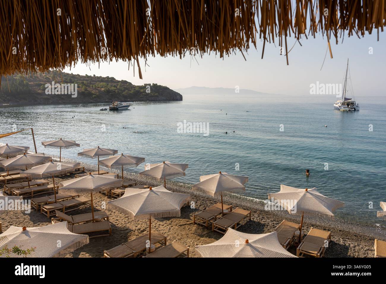 Idyllic Mediterranean beach with empty sun loungers and parasols under ...