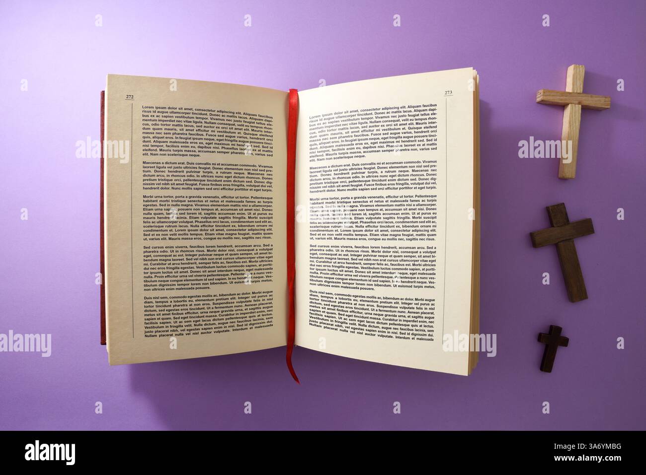 Open Bible with red registration ribbon on a purple base and wooden ...