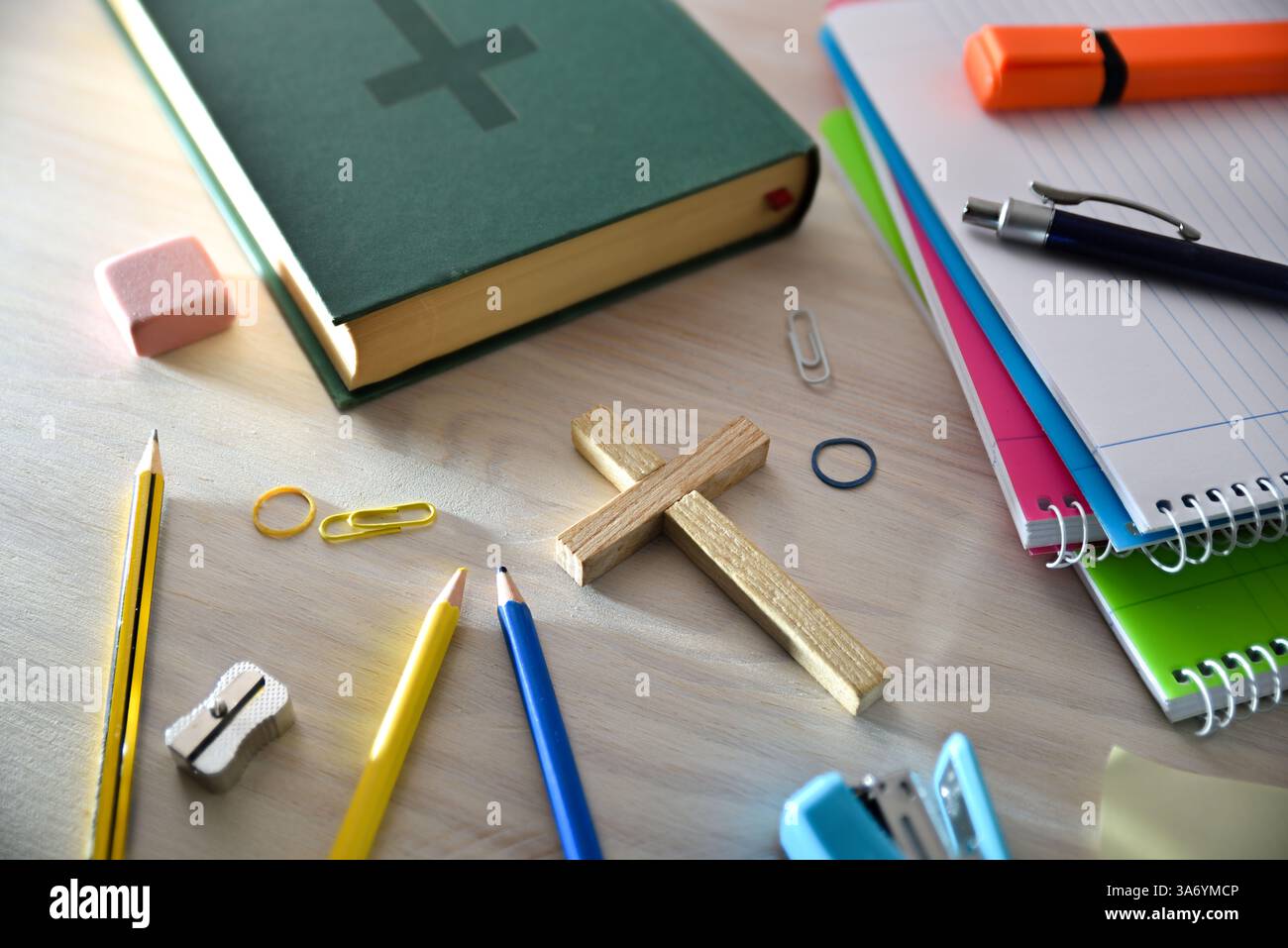 Religious education concept with a crucifix in the center of a wooden ...