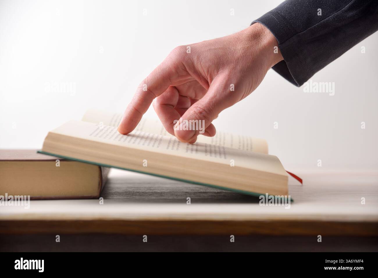 Concept of a person reading a book with a red registration tape ...