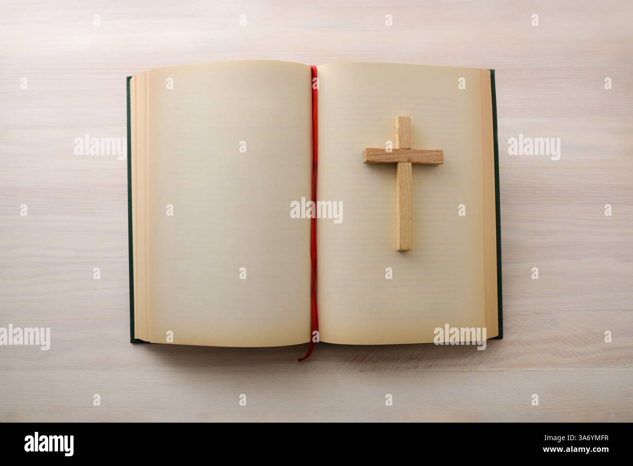 Open Bible with blank pages and wooden cross on top isolated on a ...