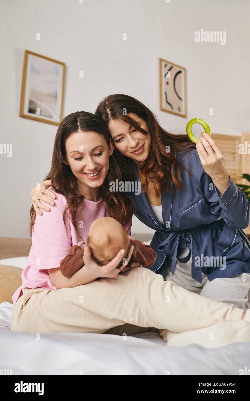 Two loving mothers hug their child on Mothers Day, filling their home ...