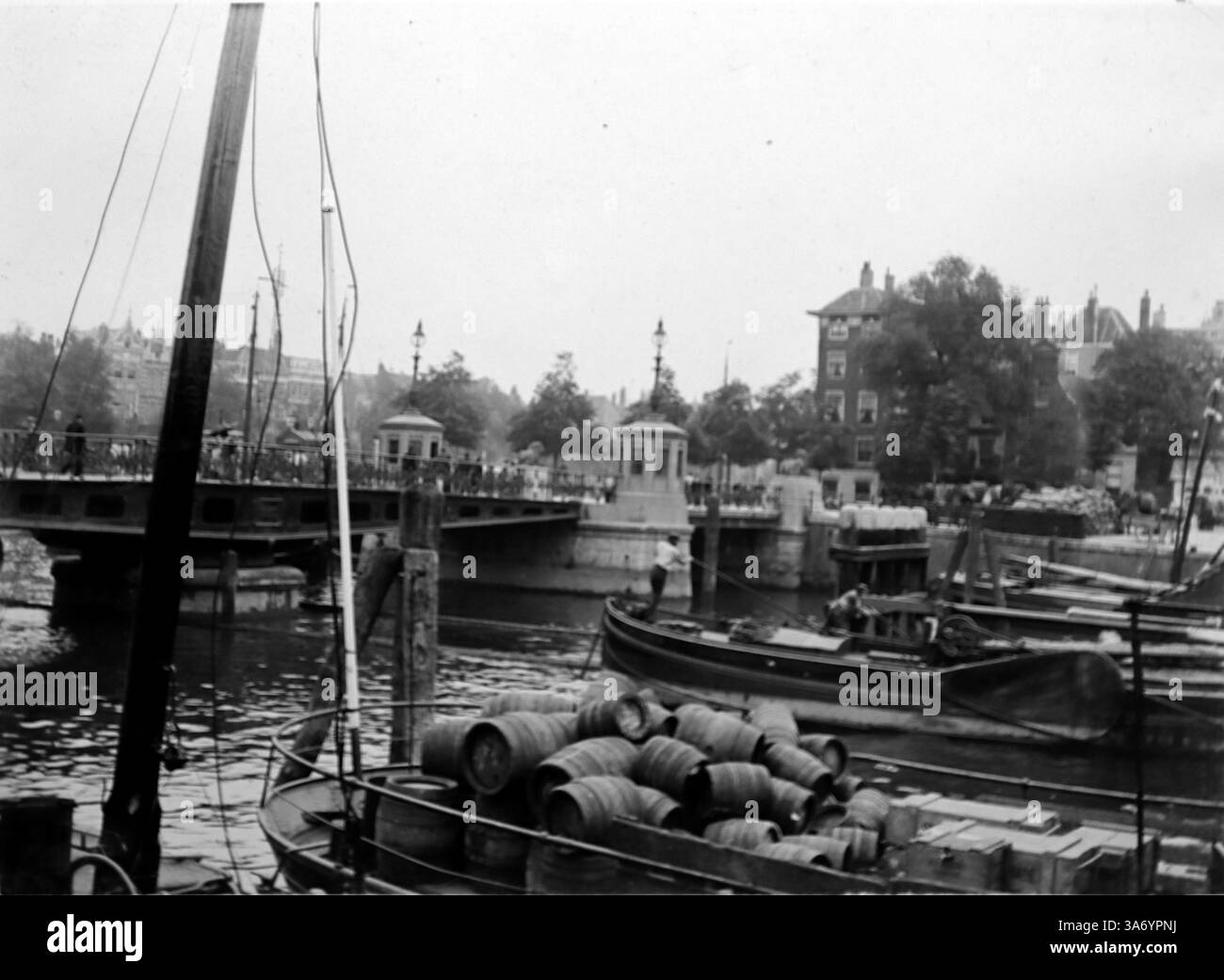 A canal in Rotterdam, Holland. A barge passing a boat laden with ...