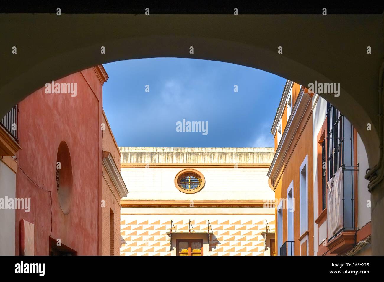 Architectural arch framing old buildings in the historic district Stock ...