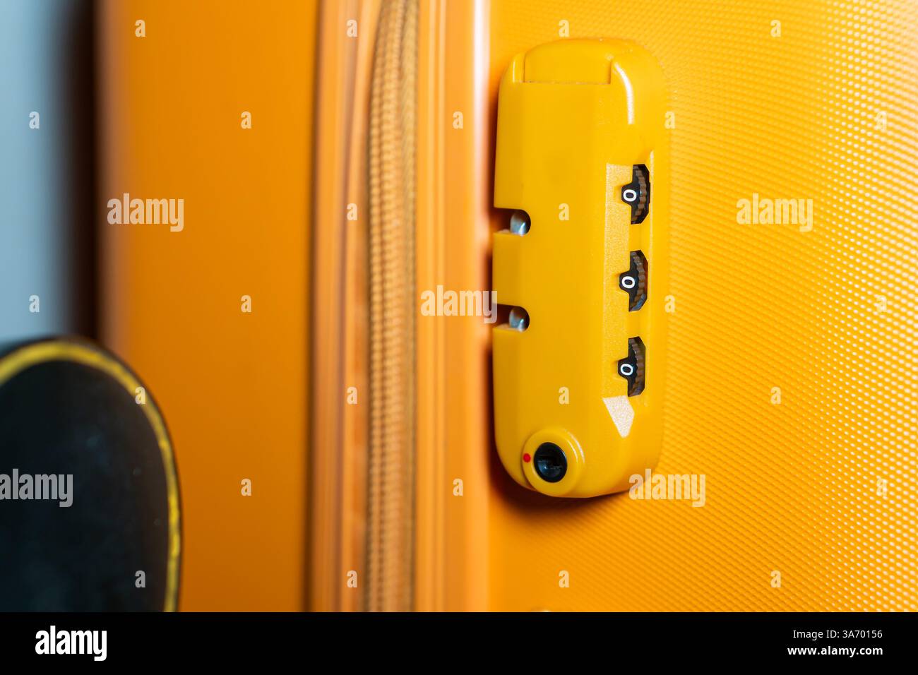 Close-up of an orange suitcase with a combination lock, showcasing its ...