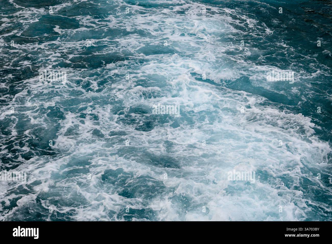 Blue foaming sea water. Natural background Stock Photo - Alamy