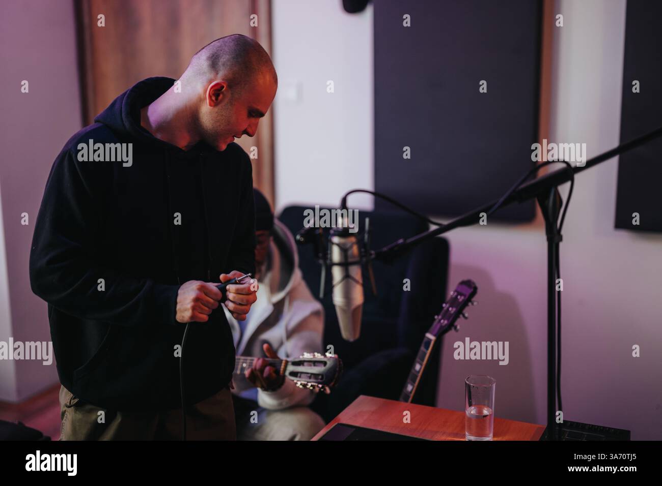 The image captures a musician and a producer working together in a ...