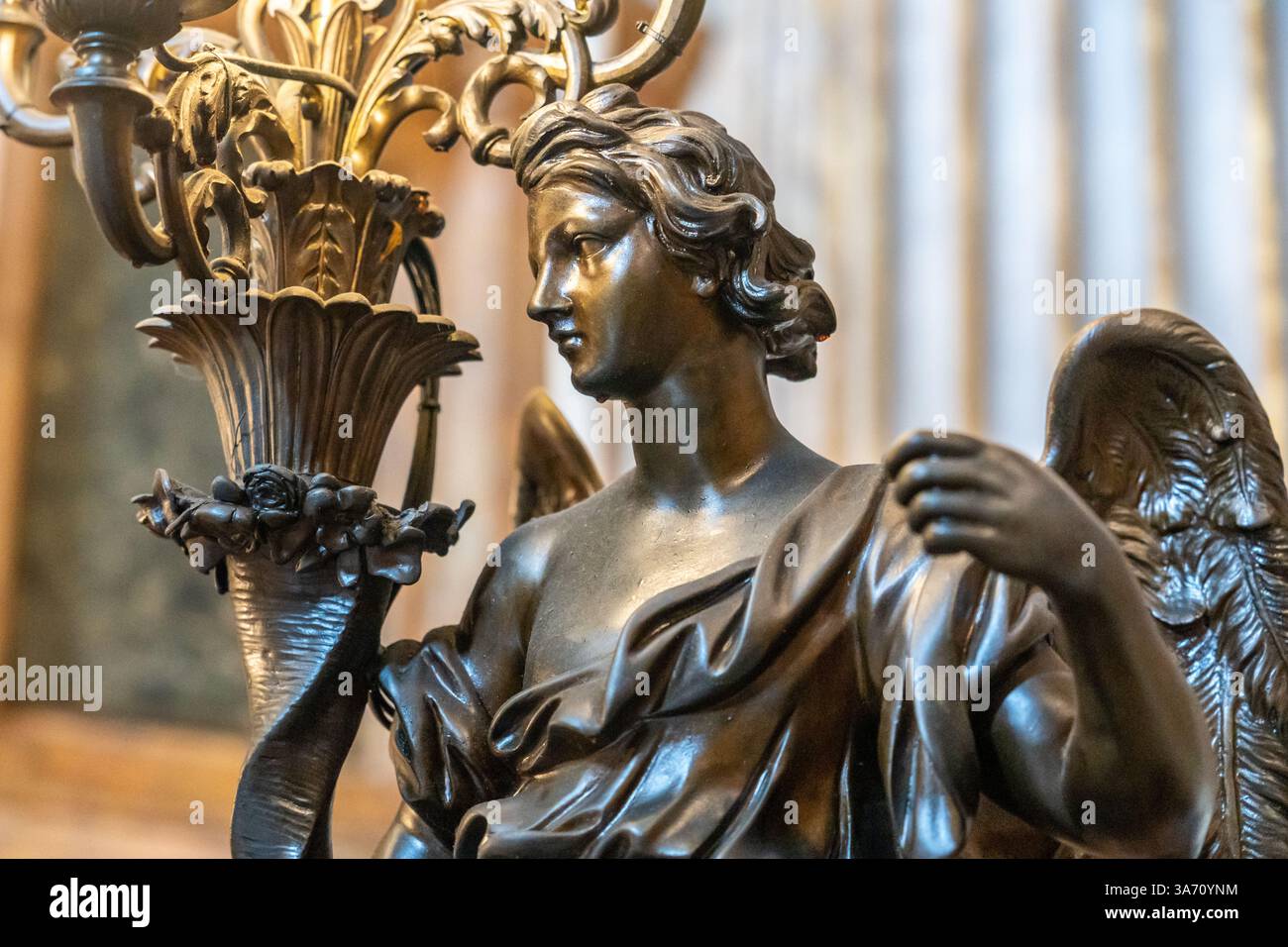 Close-up on bronze statue of angel holding a big candle stick Stock ...