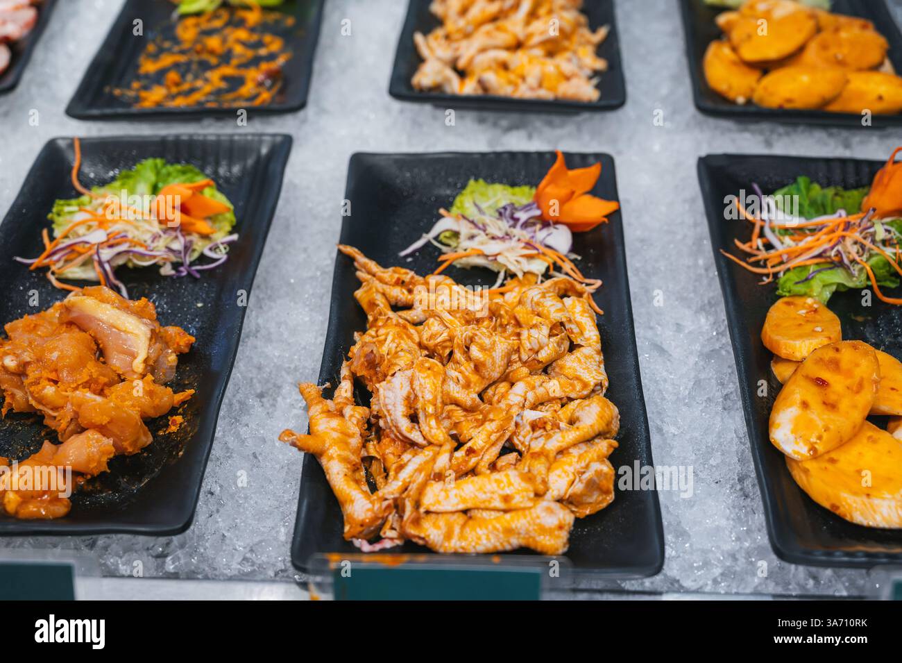 Asian buffet in a hotel in Asia. Vietnamese food meat and chicken feet ...