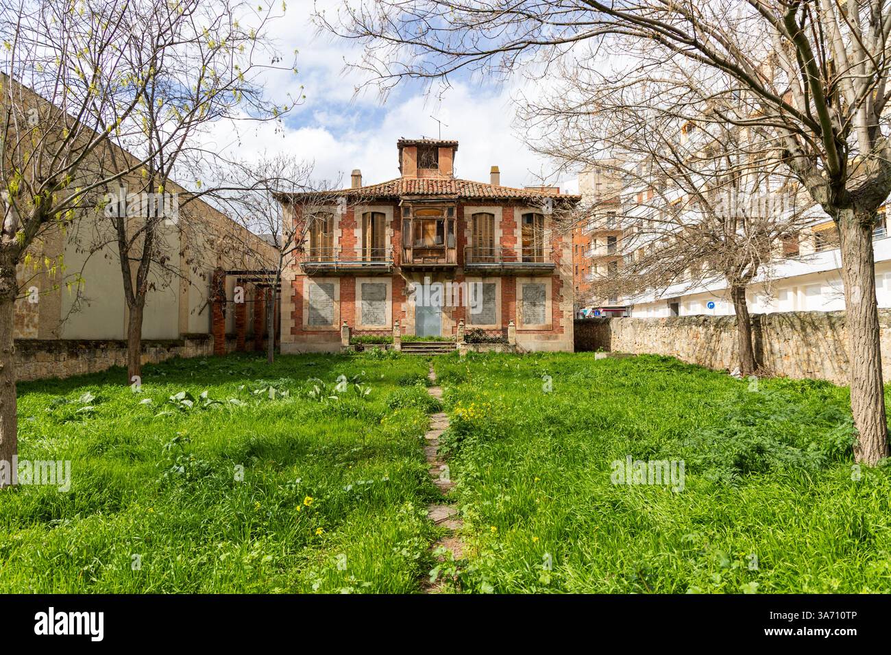 Front view of a neglected historic brick house in Salamanca, Spain ...