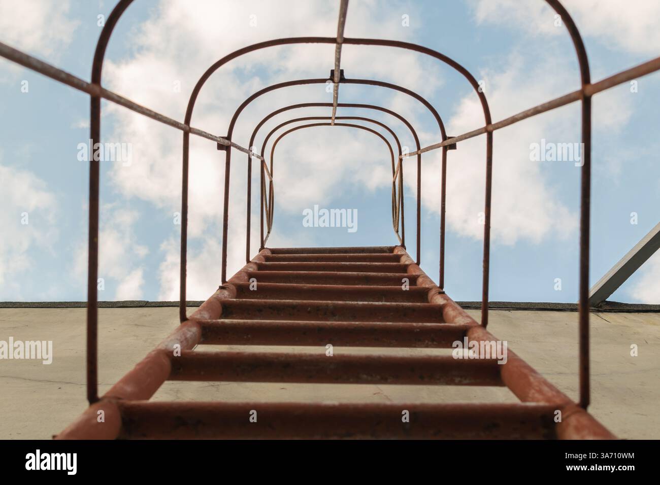 Fixed ladder red color upto the blue sky with cloud Stock Photo - Alamy