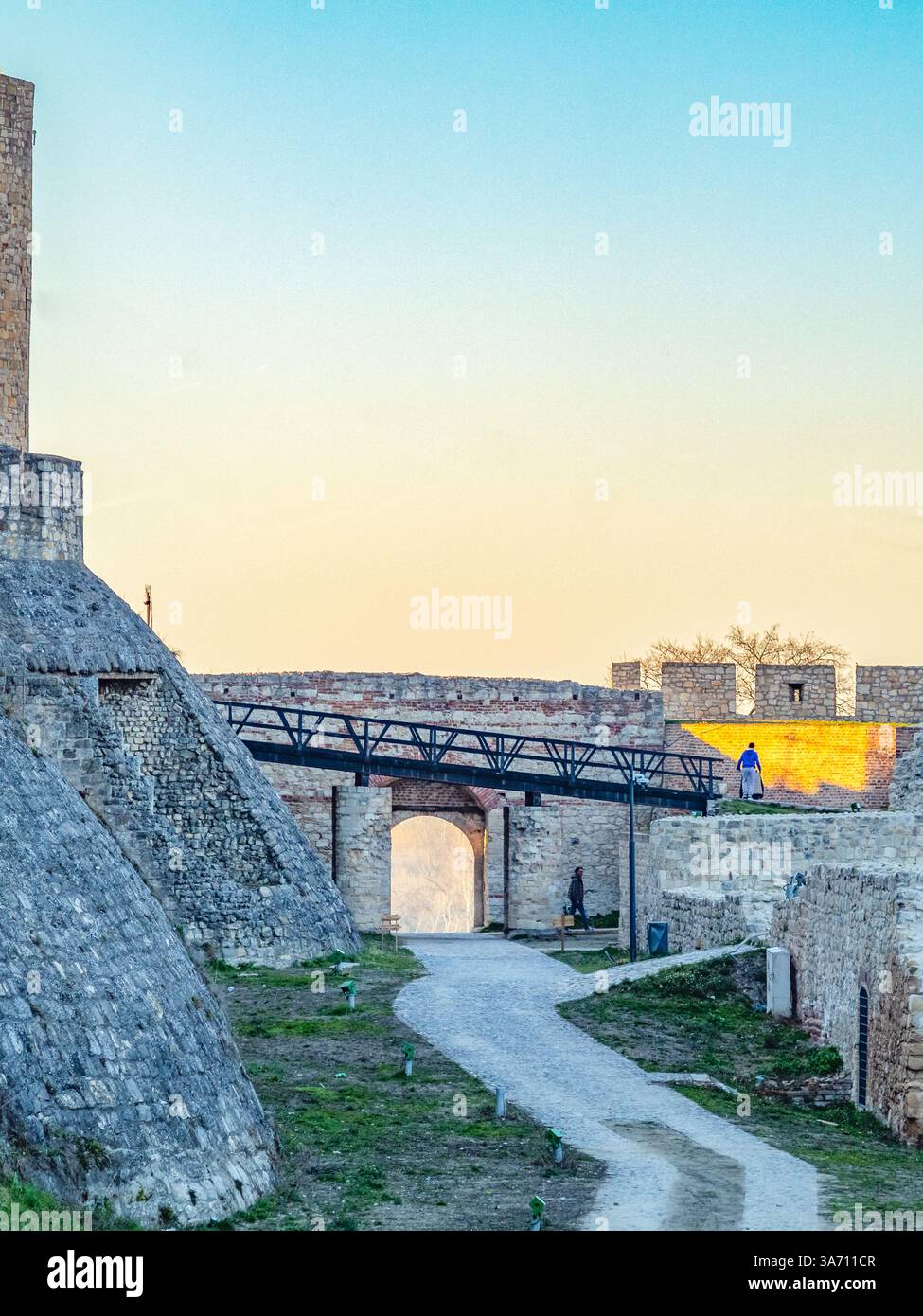 A stone fortress with historic walls and a scenic walkway under a ...