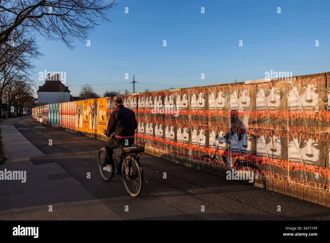 placarded construction fence on Alteburger Strasse in the district ...