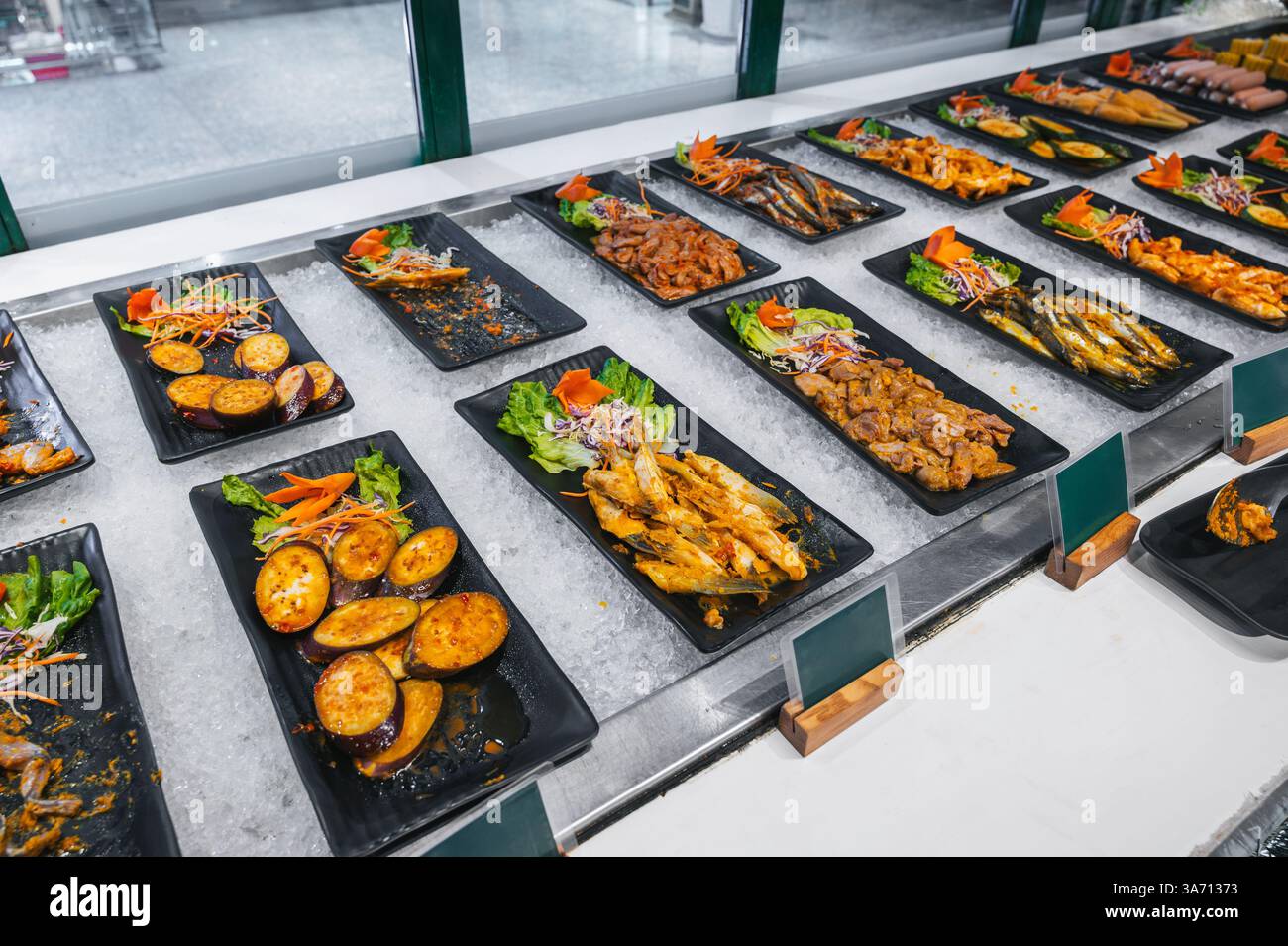 assorted of food and meat in the Asian buffet in the hotel restaurant ...