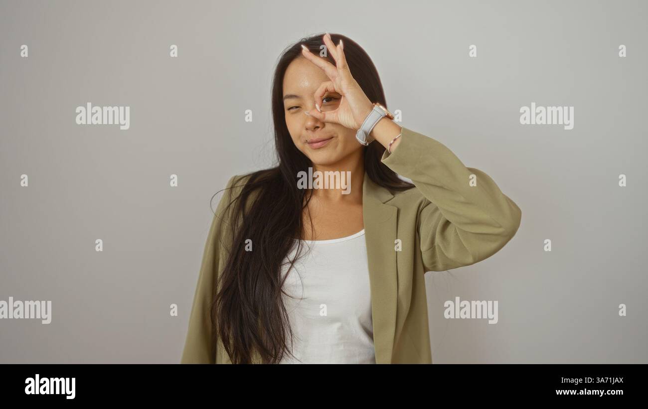Asian woman making ok gesture in front of her eye against isolated ...