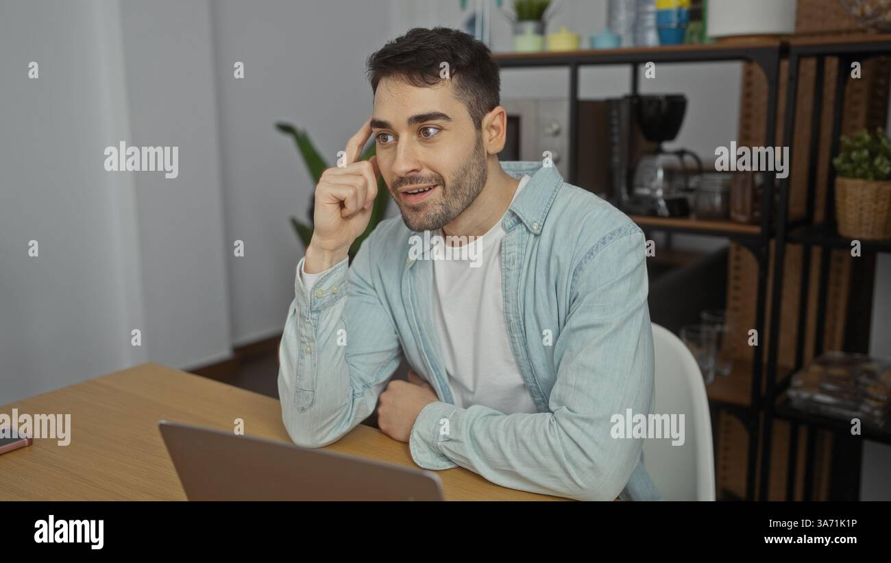 Man thinking indoors at desk in modern office environment with ...