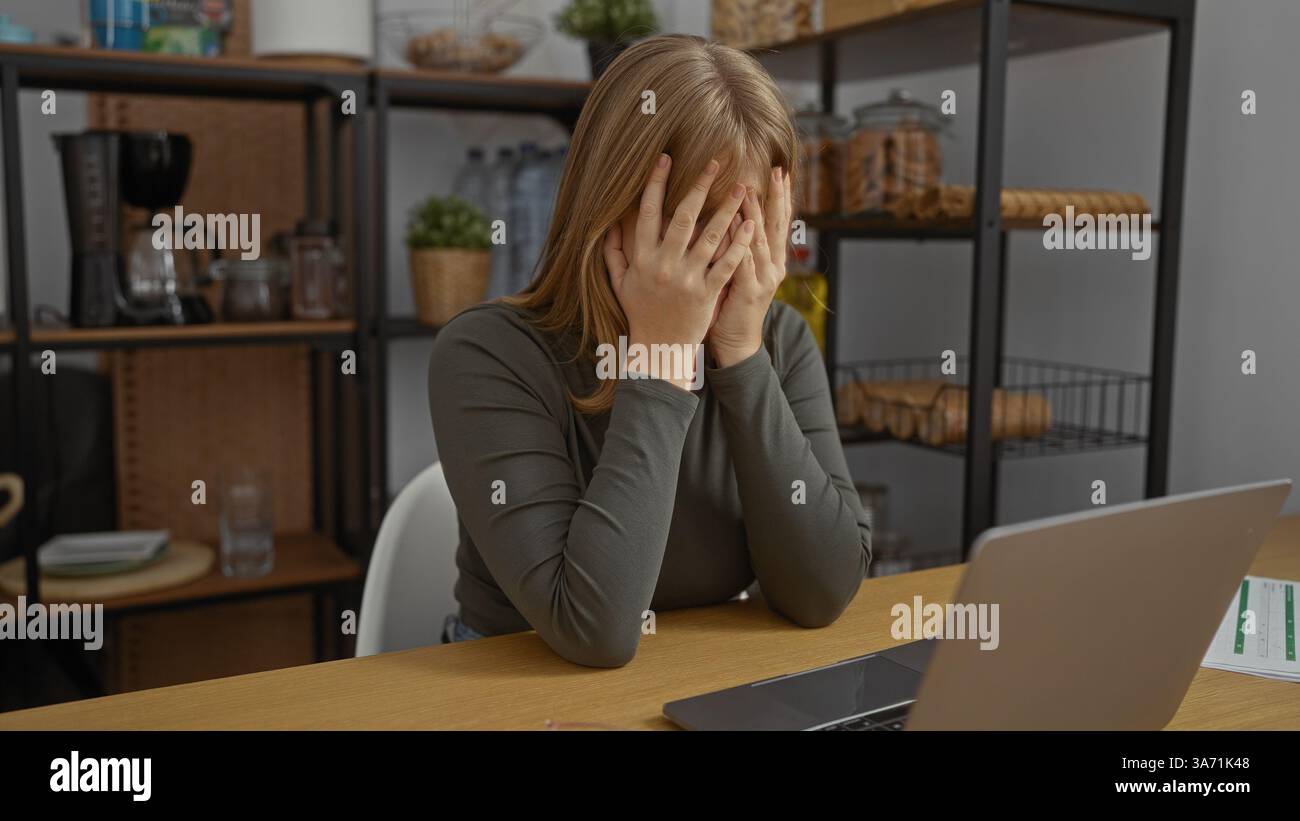 Woman stressed at work covering face with hands in modern office ...