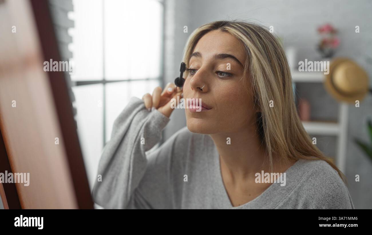 Woman applying makeup in a cozy living room with natural light ...