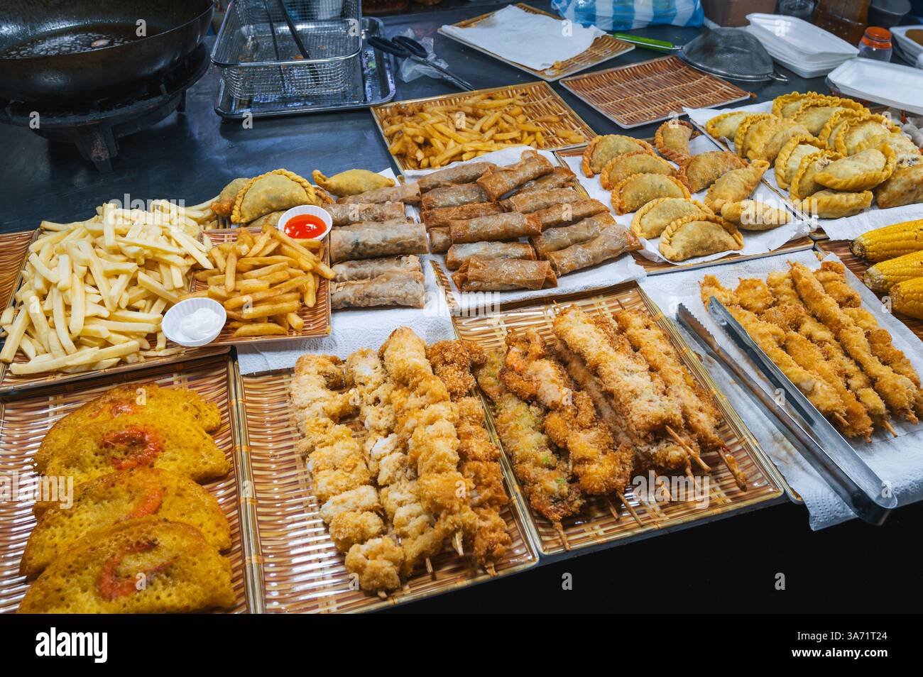 Traditional Vietnamese food and pastry on counter at the Asian night ...