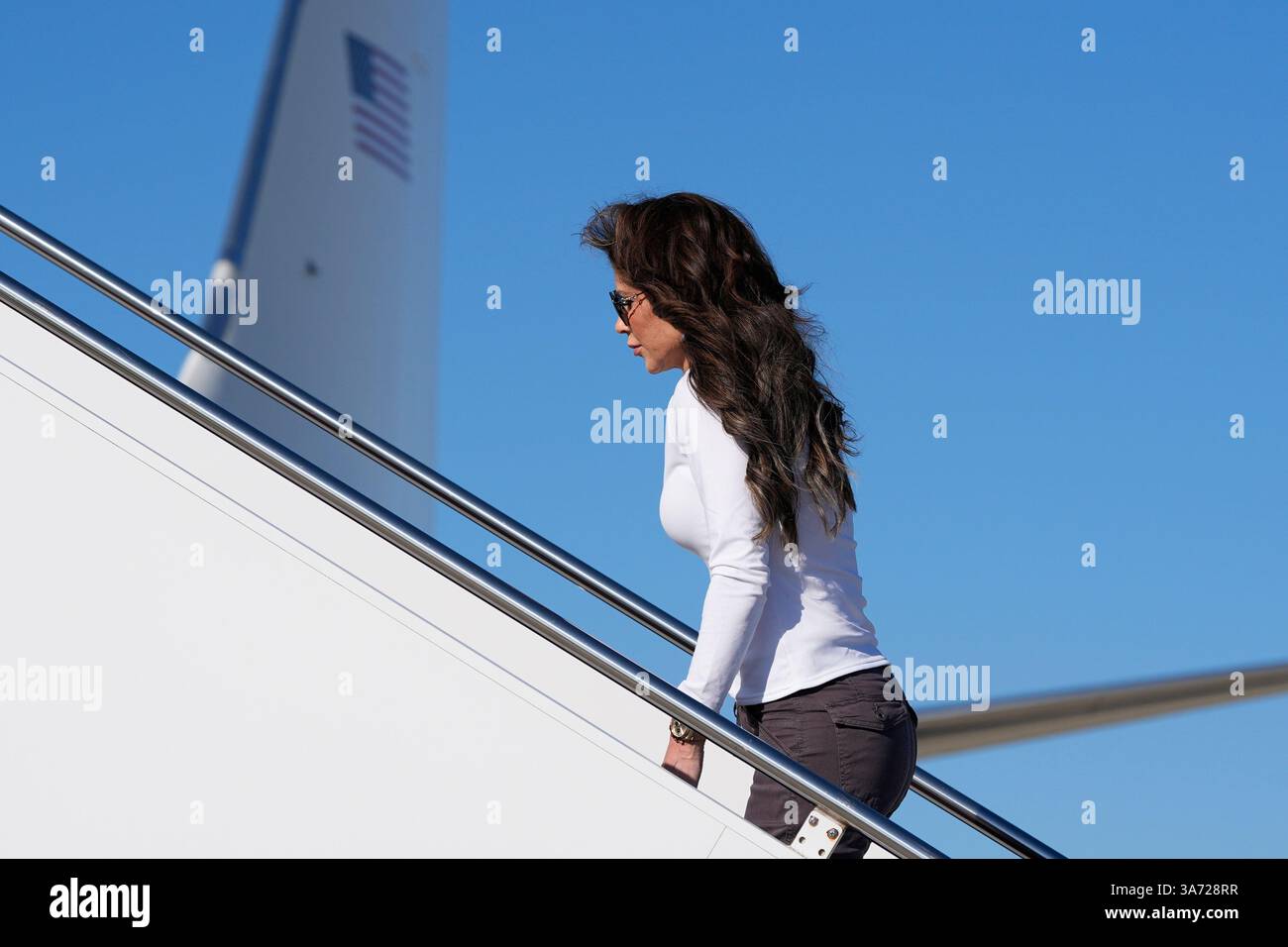 Homeland Security Secretary Kristi Noem boards her plane, Wednesday ...