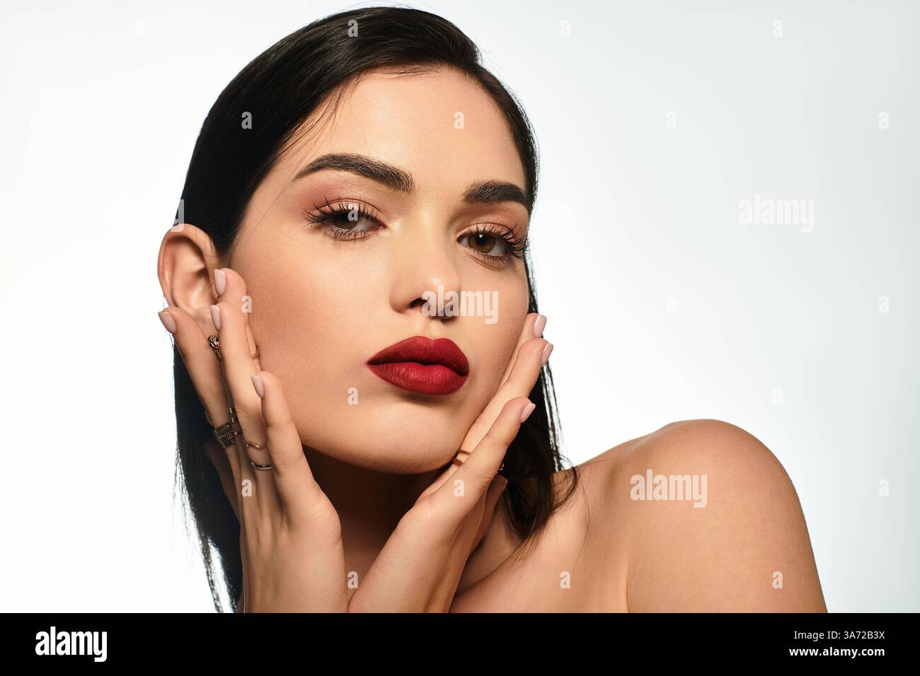 A stunning young woman with brown hair showcases her striking red lips ...