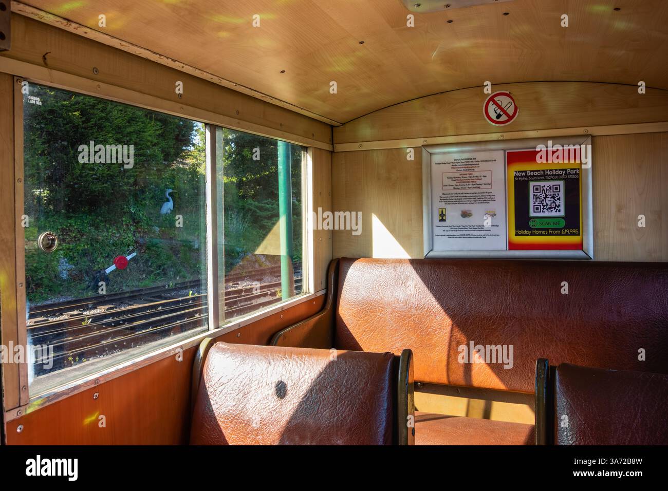 Inside a railway carriage, with sunlight streaming through the windows ...