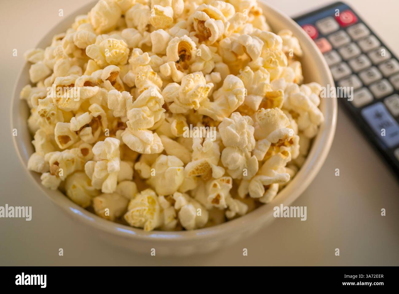 Popcorn watching tv hi-res stock photography and images - Alamy