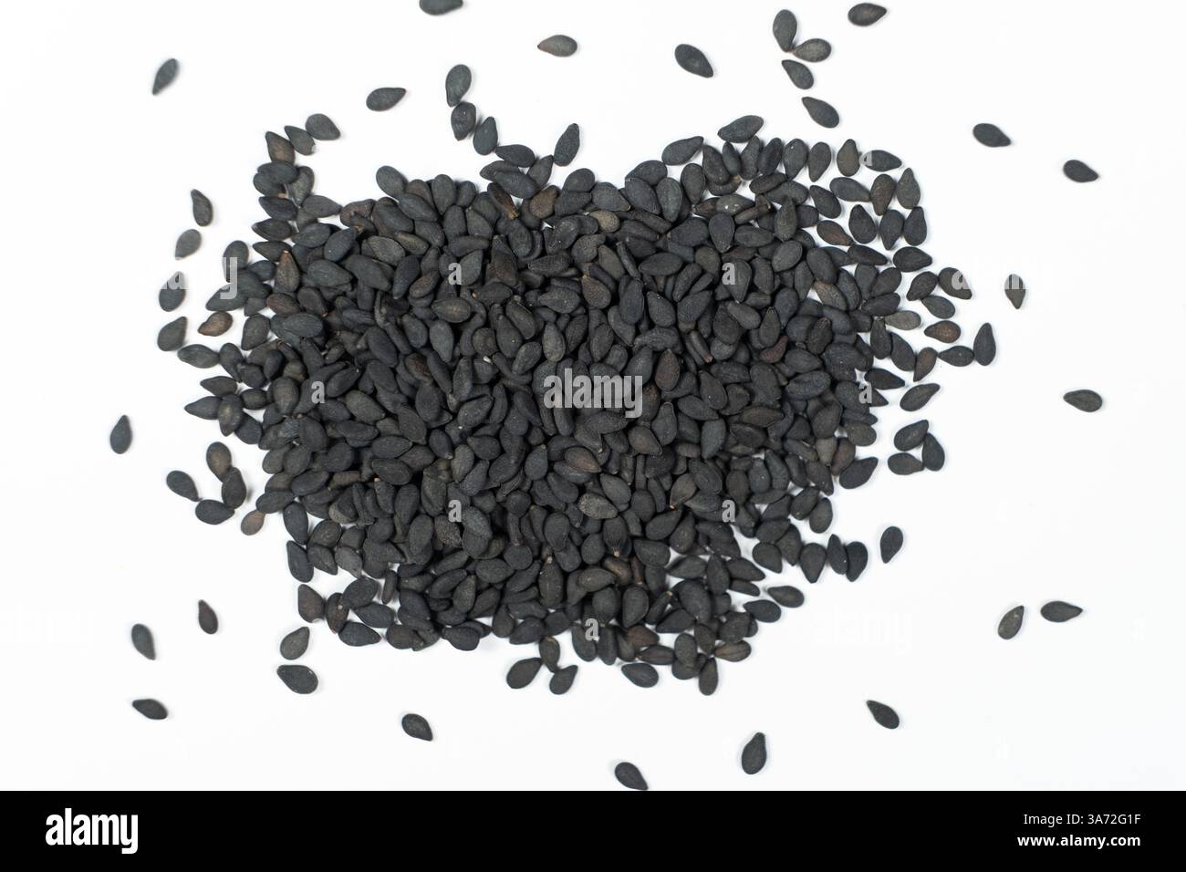 Black sesame seeds scattered on a white background macro top view Stock ...