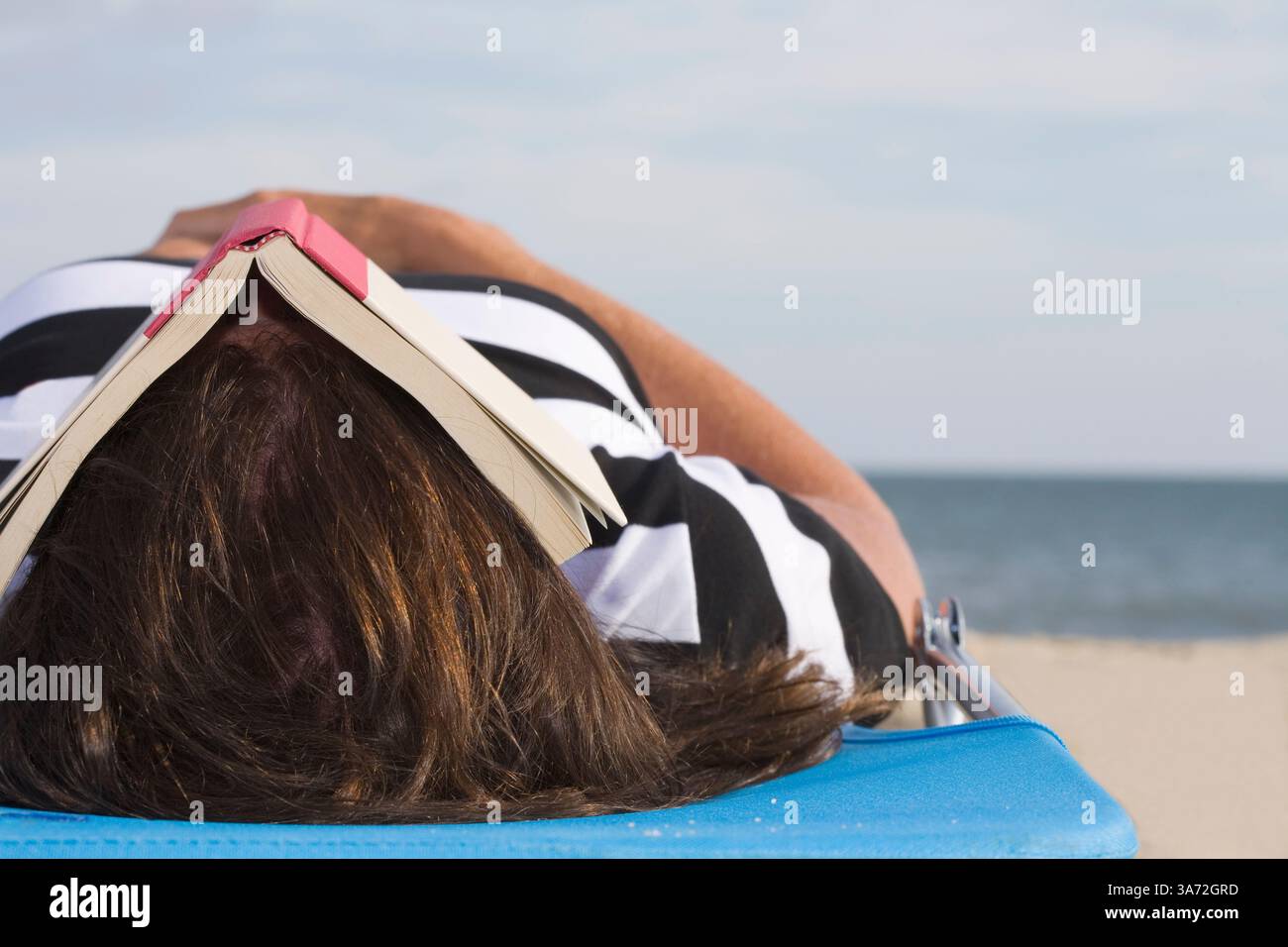 Sleeping on beach with book on face hi-res stock photography and images ...