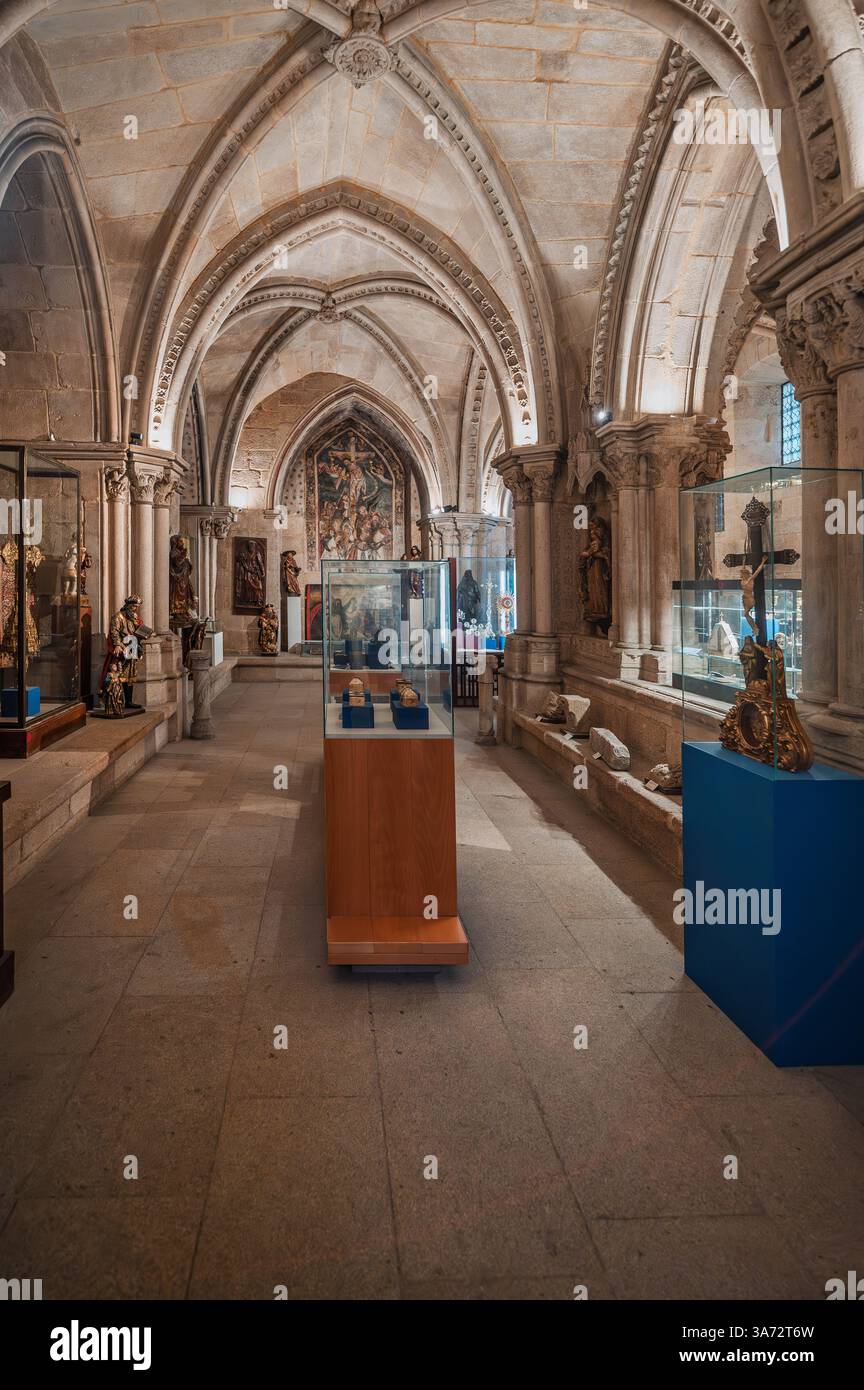 Stone arches and columns frame display cases containing religious ...