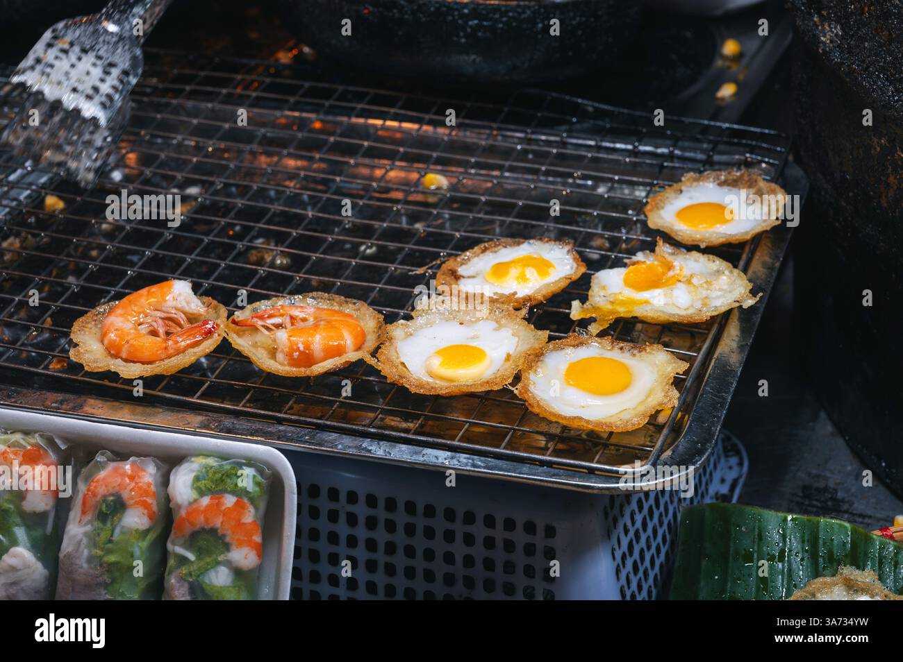 cooked traditional Vietnamese dish Banh Khot with shrimps and corn at ...