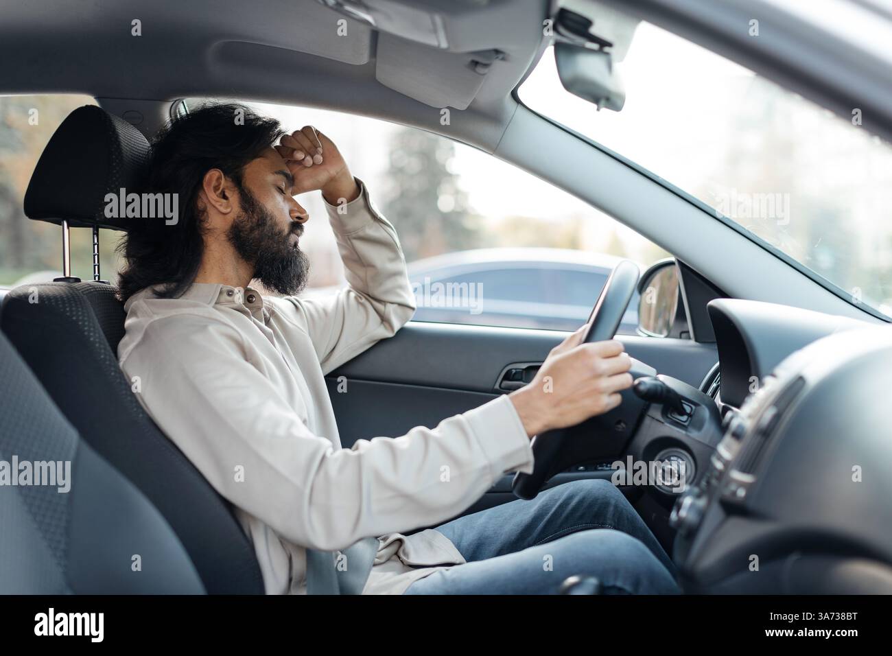 Indian man in car showing frustration or fatigue, eyes closed Stock ...