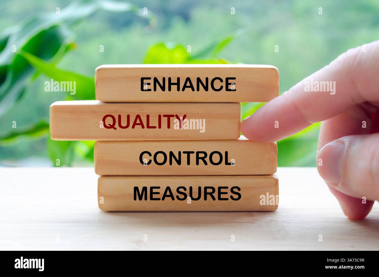 Enhance Quality Control Measures text on wooden blocks representing ...