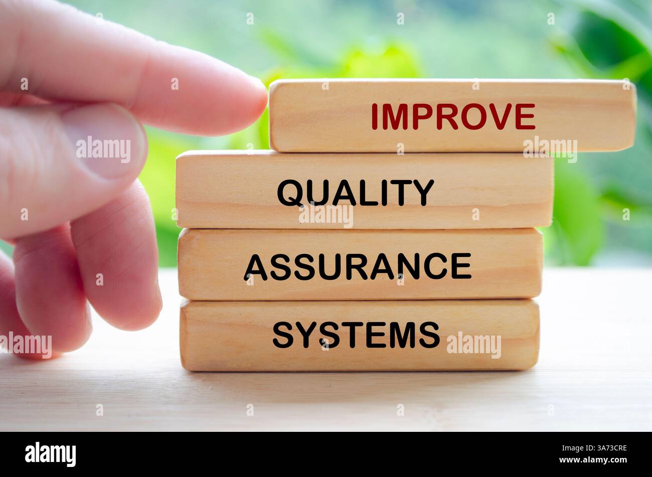 Improve Quality Assurance Systems text on wooden blocks representing ...