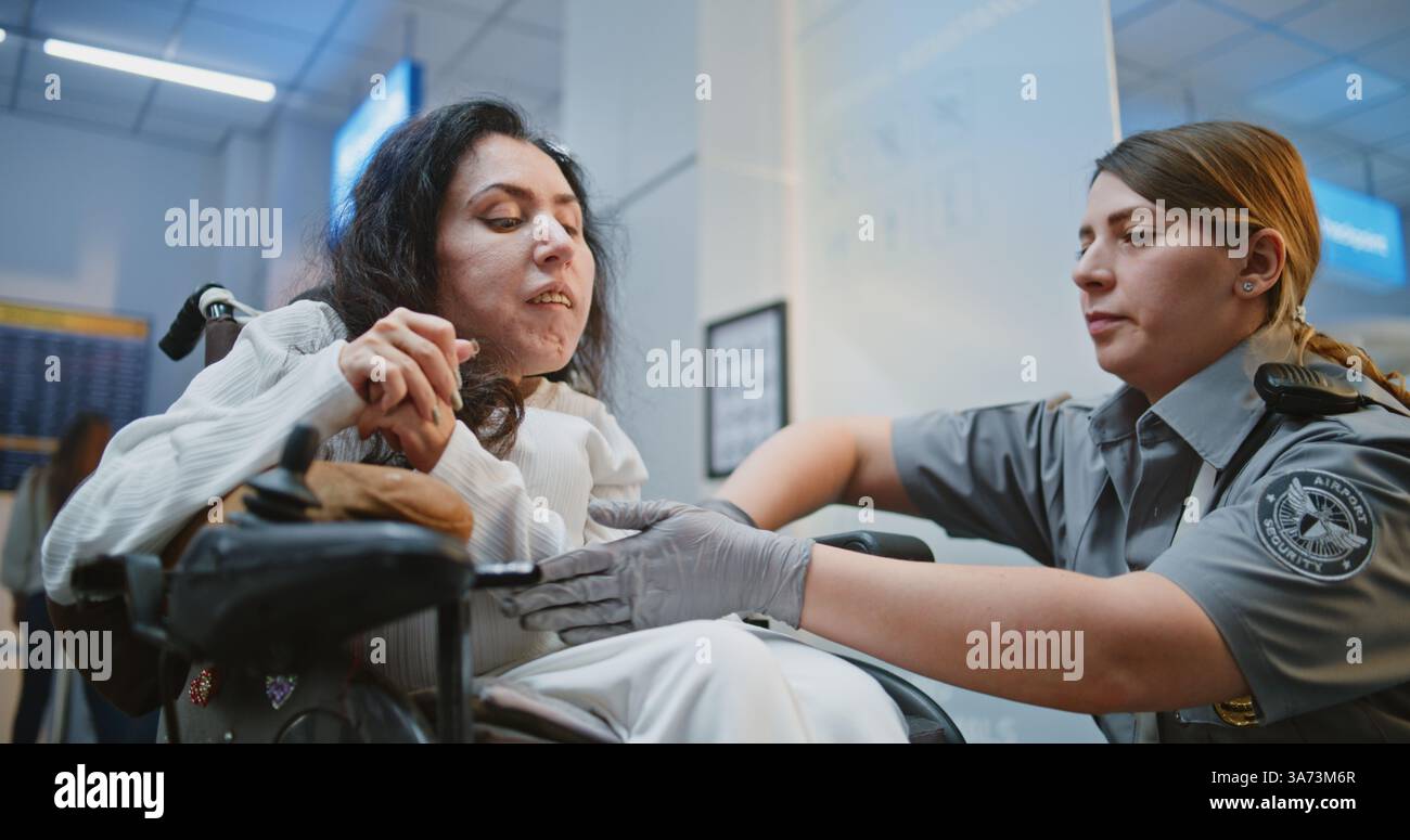 Security Worker Walks with Woman with Physical Disability to Security Checkpoint in Airport ...