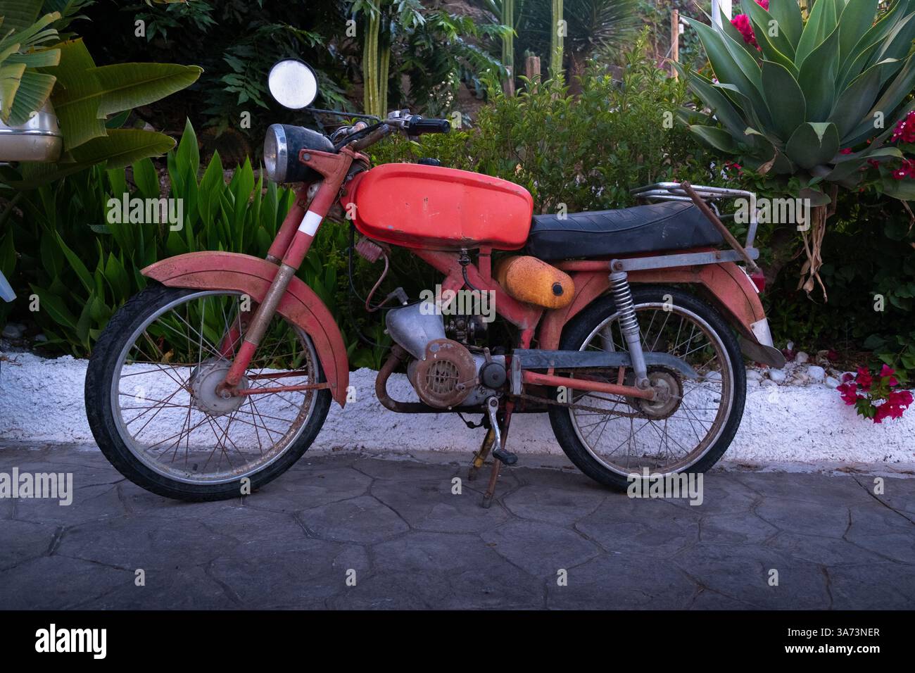 Side view of an old -looking motorcycle and vintage red. It is a 49 cm ...