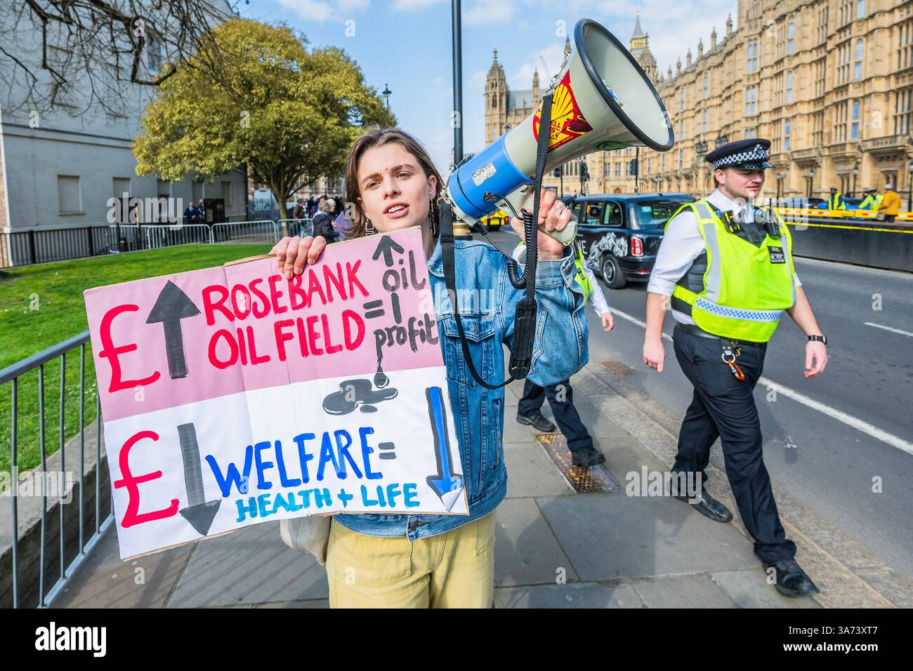 London, UK. 26th Mar, 2025. Environmental protesters try to get their ...