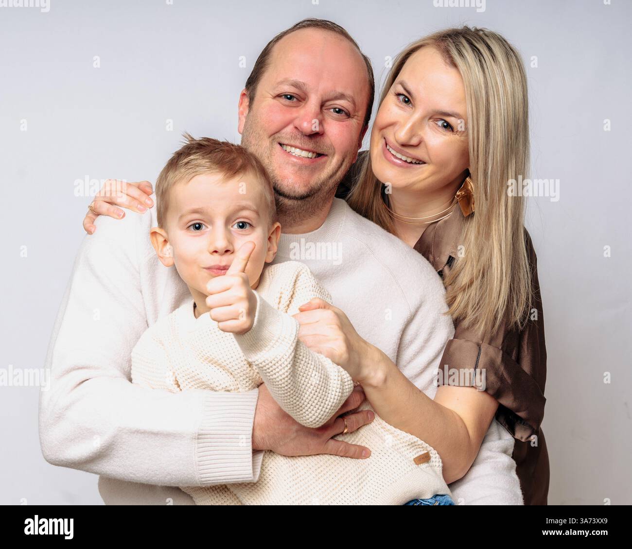 European happy family with son 4 years old, studio shot waist-high ...