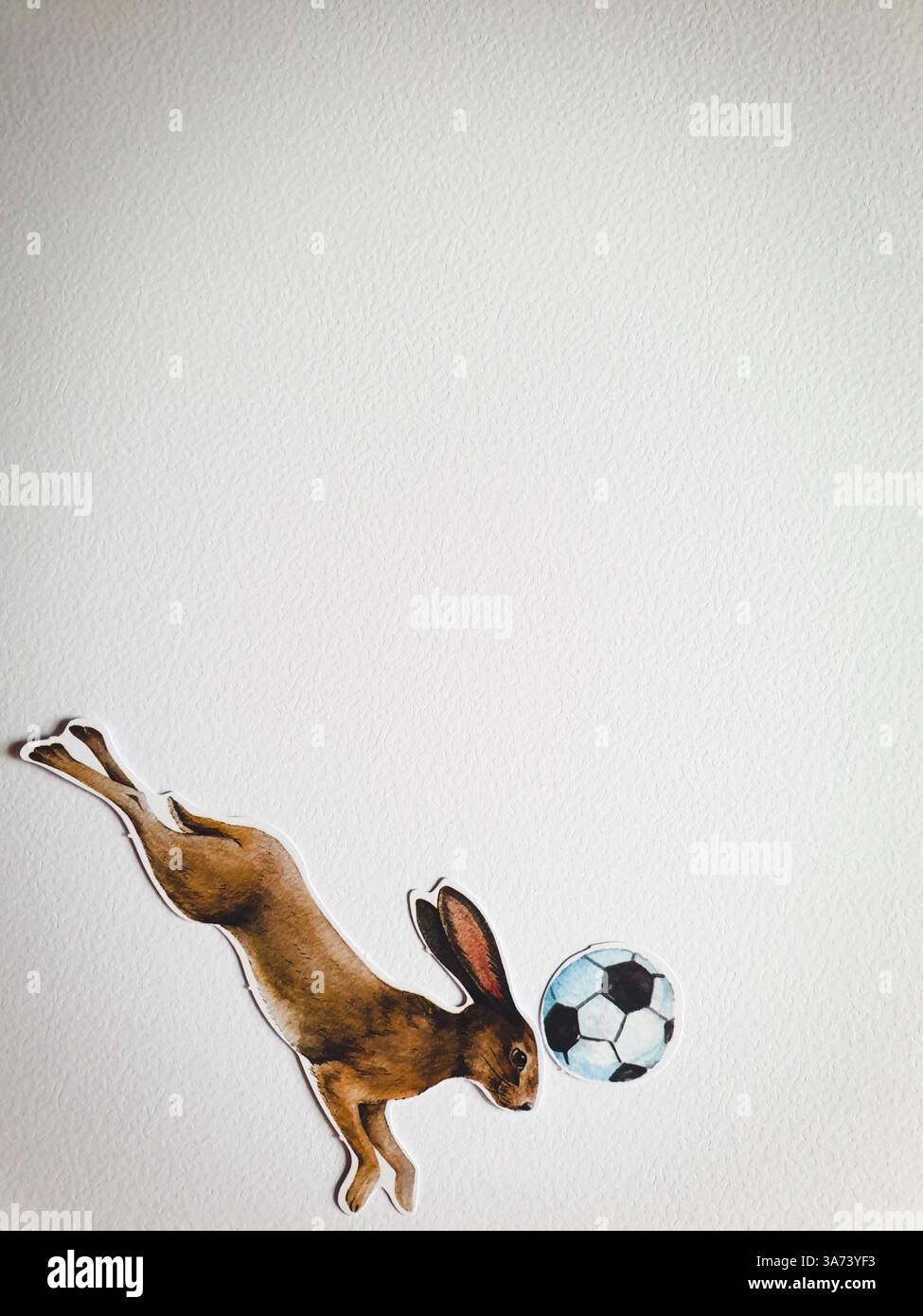A rabbit jumping after a ball Stock Photo - Alamy