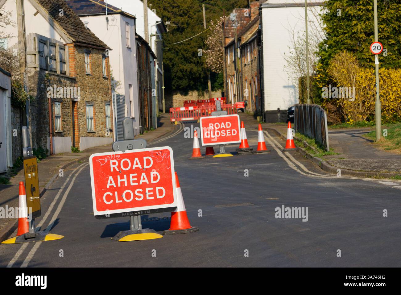 "Road Ahead Closed" and "Road Closed" signs and traffic cones on ...