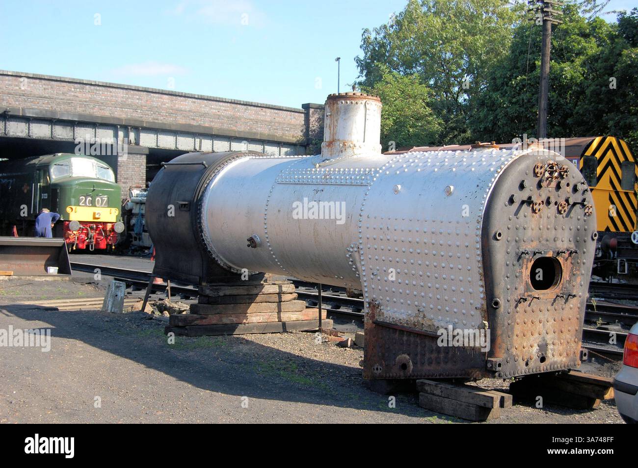 The boiler of a steam locomotive stands in the open, ready for ...