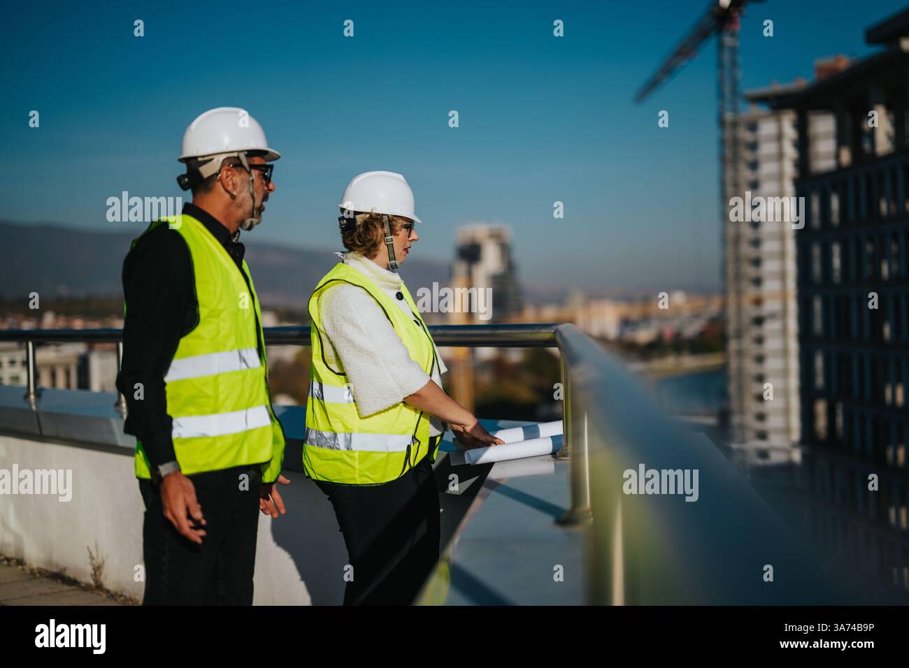 Architects discussing building plans at a construction site Stock Photo ...
